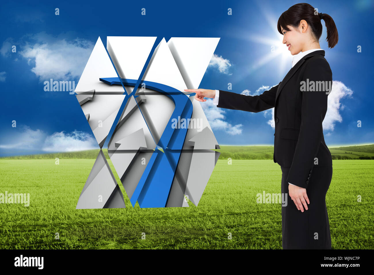 Smiling businesswoman pointing against sunny brown landscape with street Stock Photo - Alamy