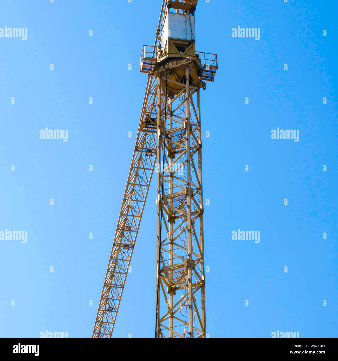 crane on blue sky background Stock Photo - Alamy