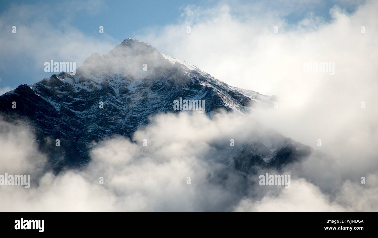 Sharp Mountain Peak High Above the Clouds Stock Photo - Alamy