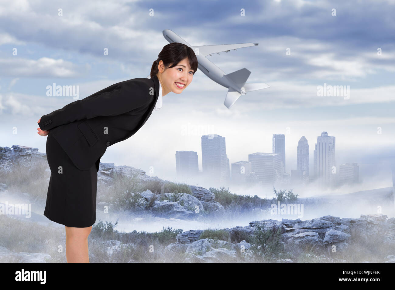 Smiling businesswoman bending against misty green landscape with street ...
