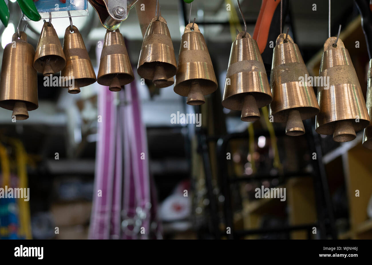 Row of hanging bells from small to large Stock Photo - Alamy