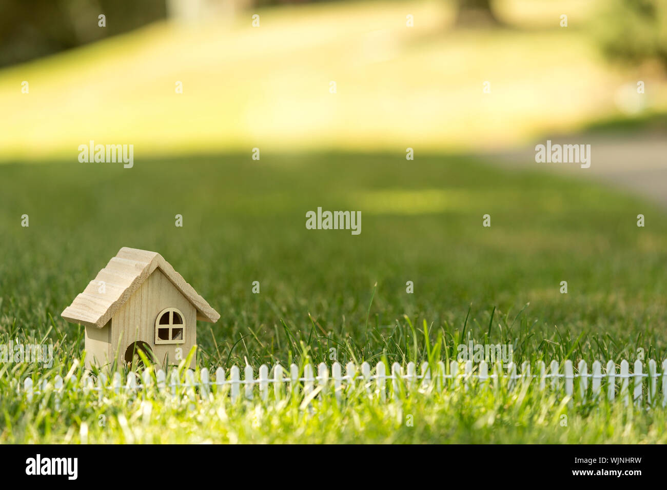 Little house on grass in sun light Stock Photo - Alamy