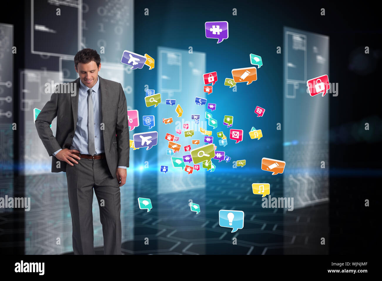 Smiling businessman with hand on hip against hologram on black background with hexagon pattern ...