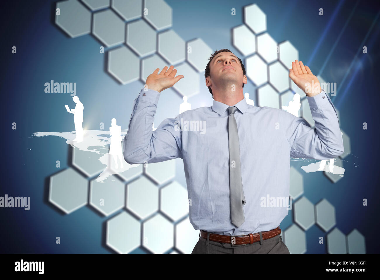 Businessman standing with arms pressing up against technological ...