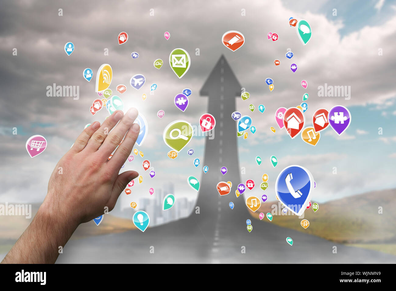 Hand presenting against road turning into arrow Stock Photo - Alamy