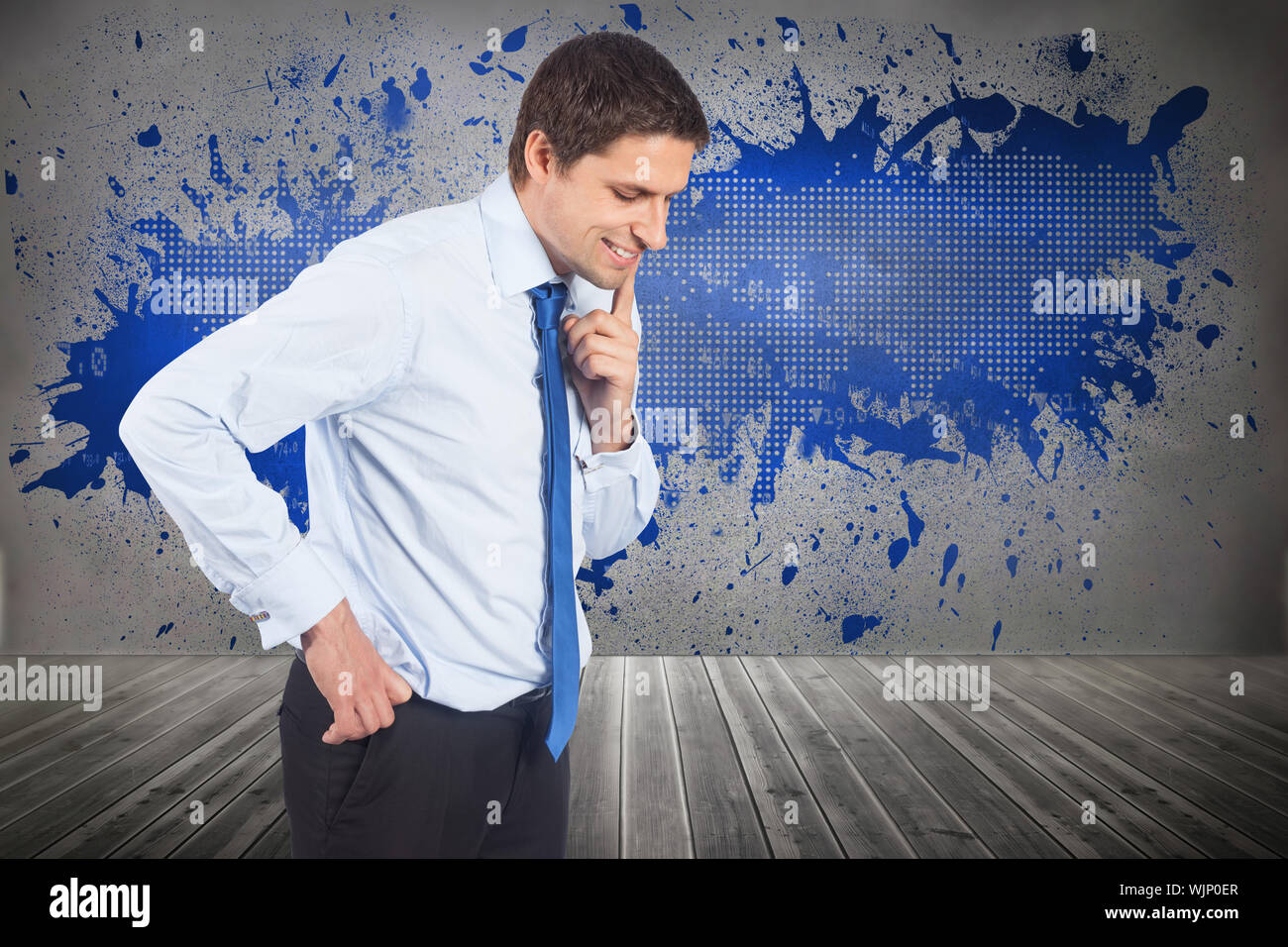 Thinking businessman touching his chin against splash on wall revealing ...