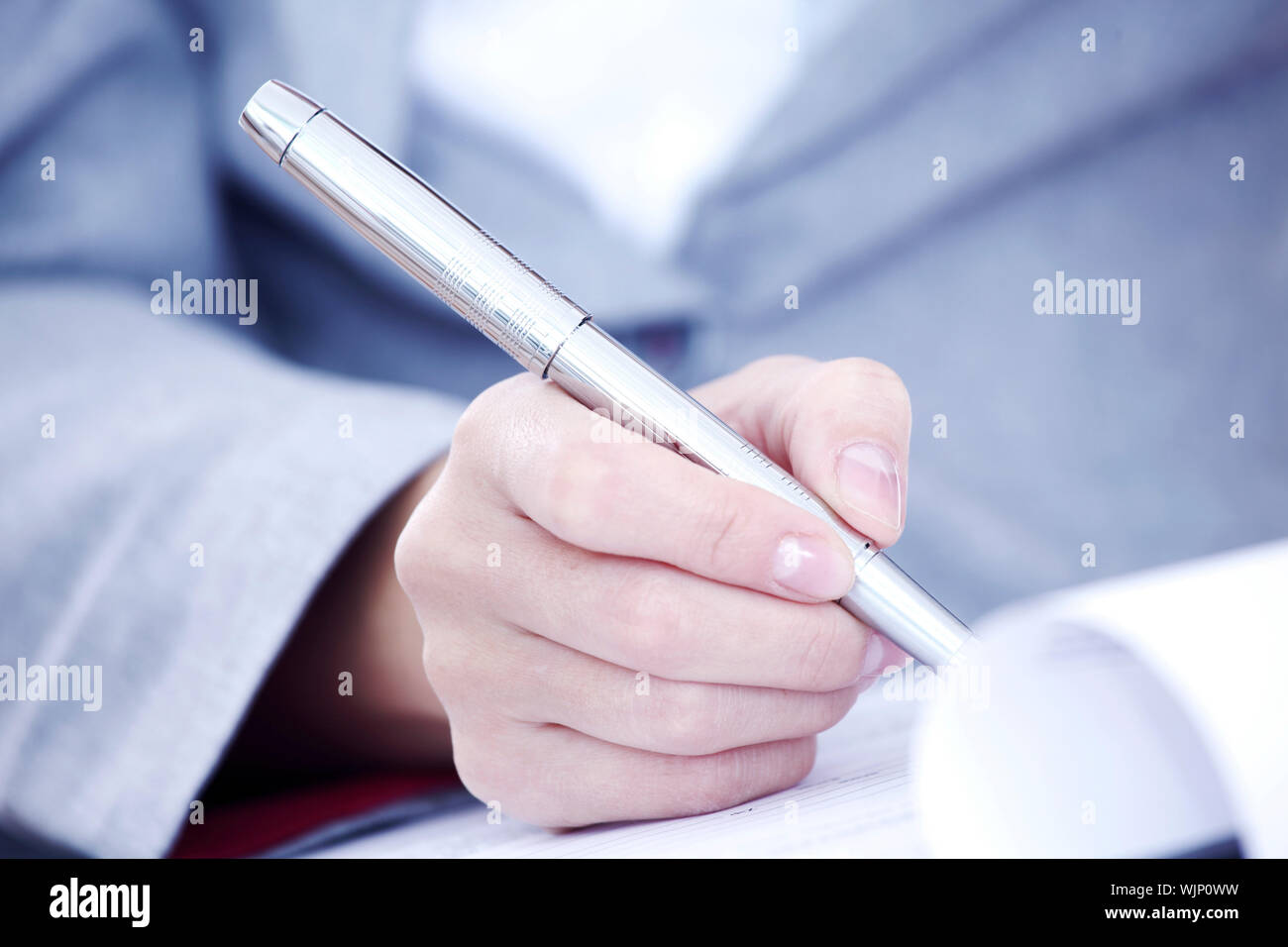 Extreme close up of female business hand signing document Stock Photo ...
