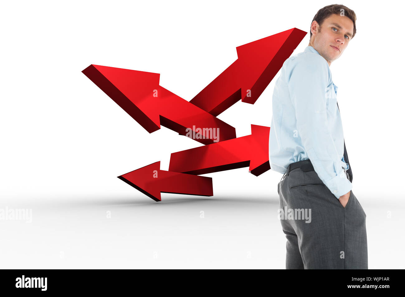 Serious businessman standing with hands in pockets against red arrows ...