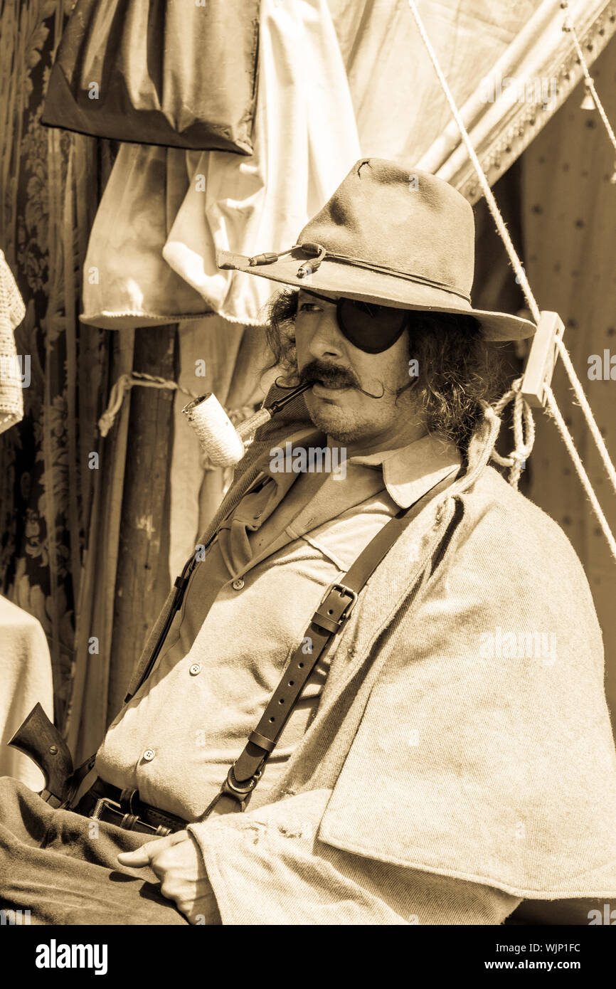 Confederate soldiers smoking a pipe at an encampment during an American ...