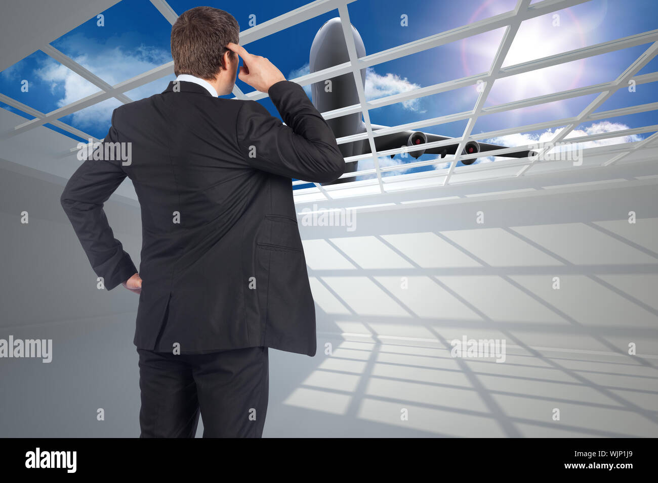 Thinking businessman scratching head against airplane flying over ...