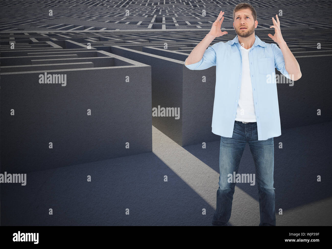 Reproachful man looking up against entrance to difficult maze puzzle ...