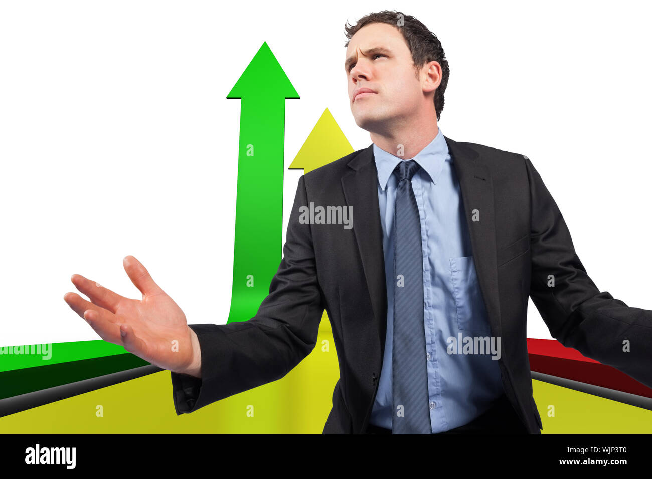 Businessman posing with arms up against stony path leading to misty ...