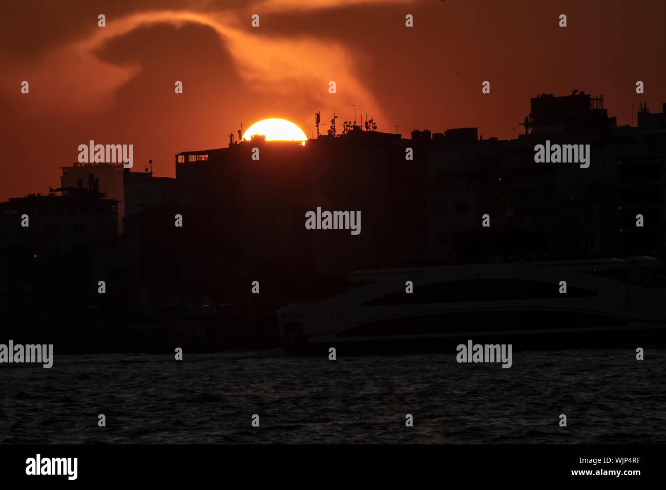 Sunset sea and city landscape Stock Photo - Alamy