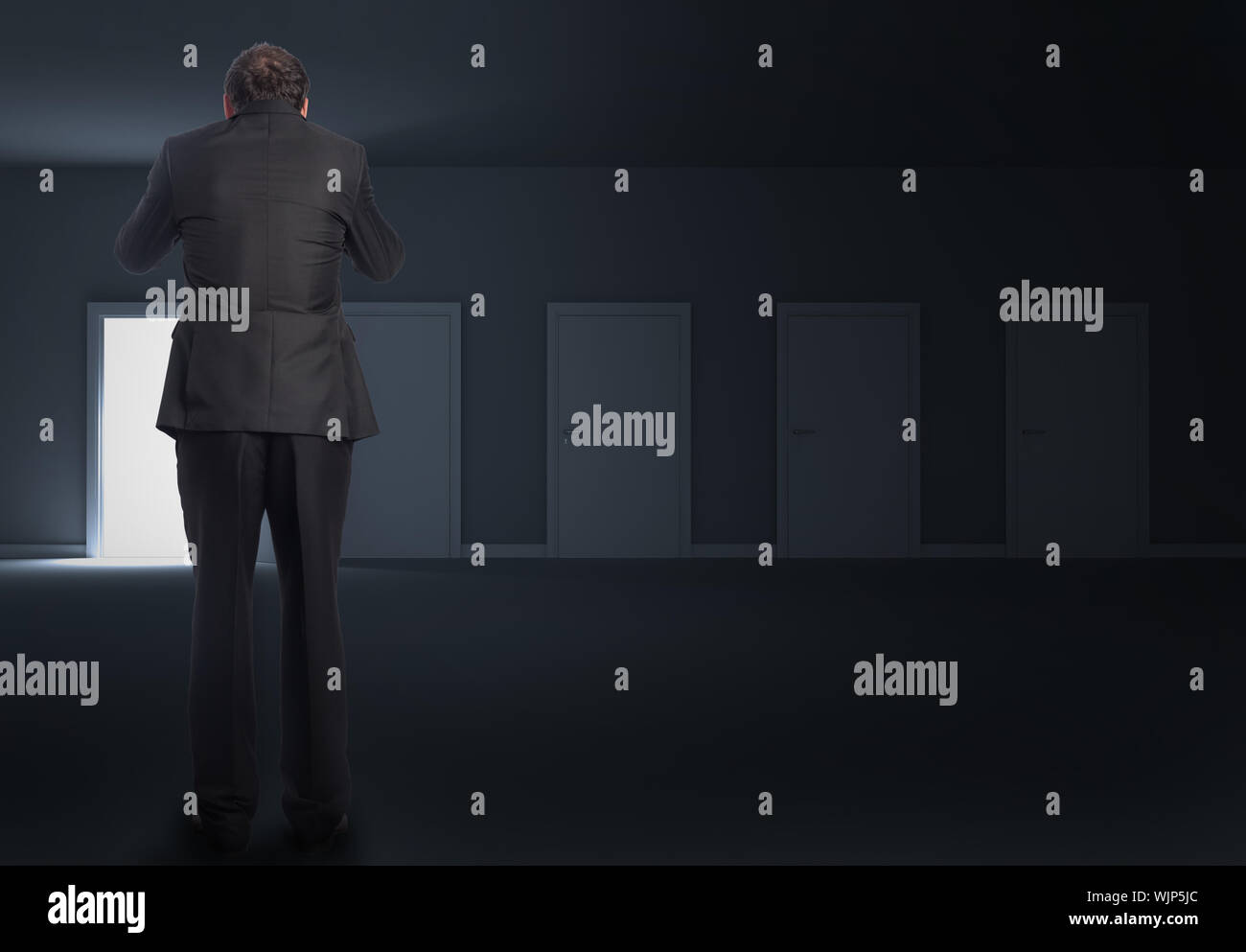 Shouting businessman against door opening to show red arrow Stock Photo ...