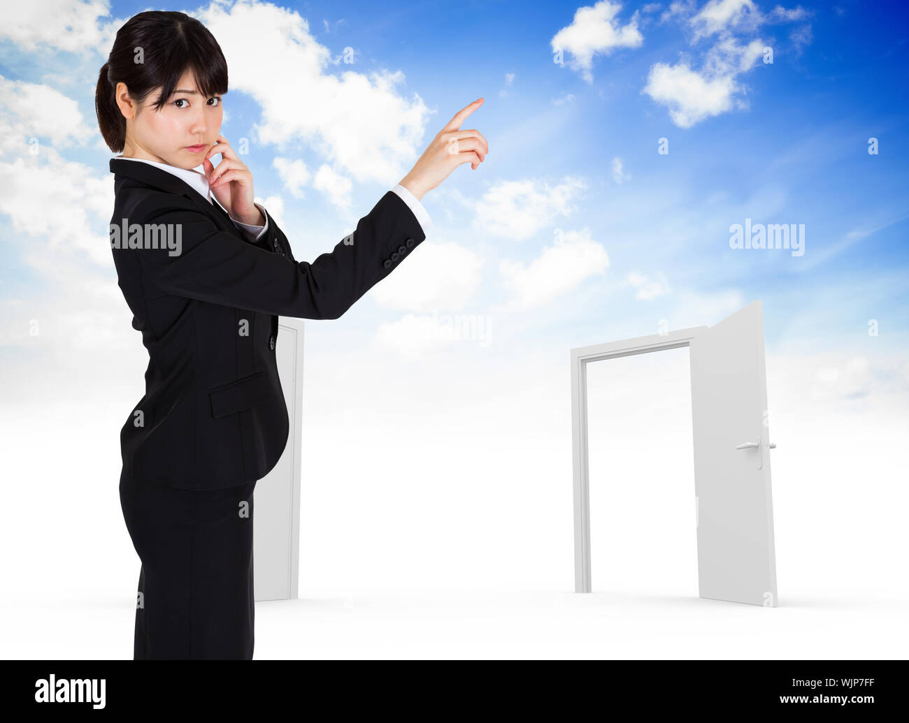 Focused businesswoman pointing against doorway standing on floorboards ...