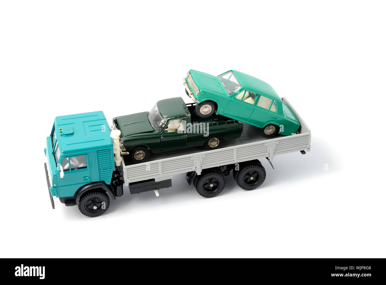 Toy cars in the back of toy truck on a white background Stock Photo - Alamy