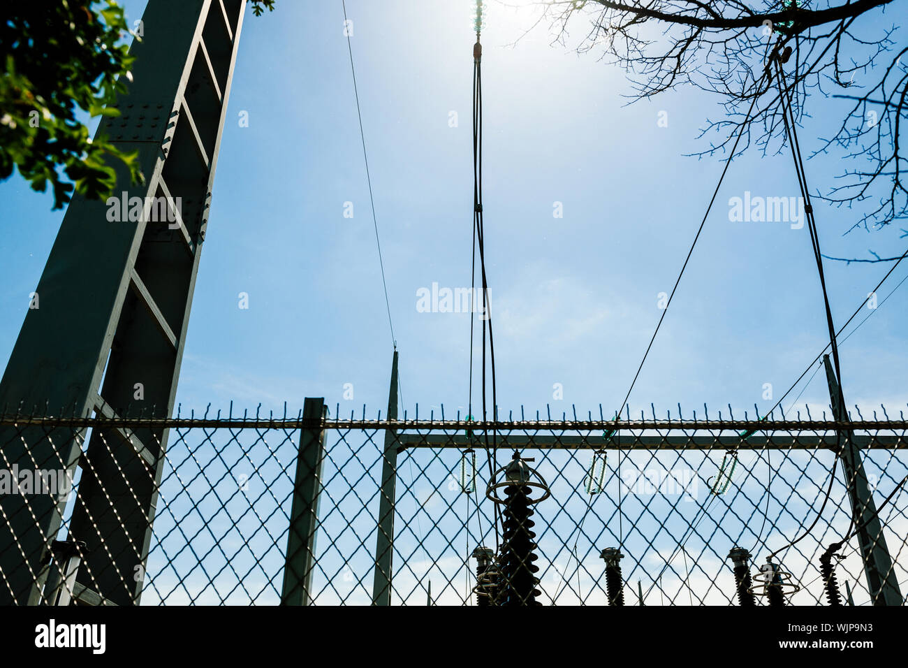 Low angle view of high voltage French power lines against blue sky ...