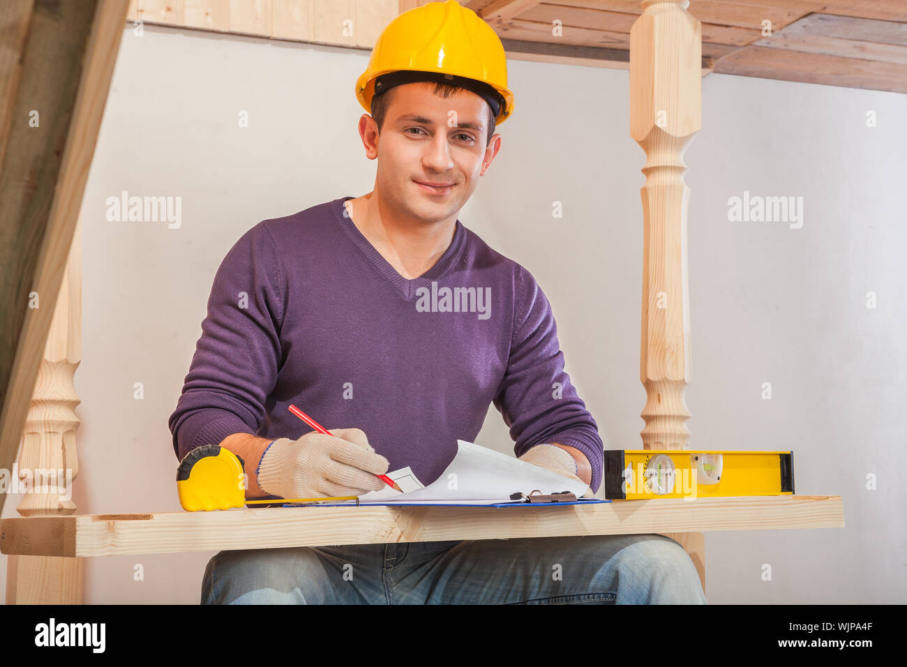 young worker drawing with pencil in blueprint Stock Photo - Alamy