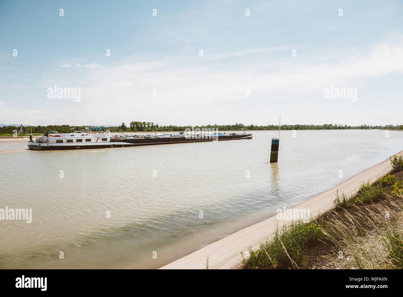 Wide image of large barge cargo boat on the Rhine River transporting ...