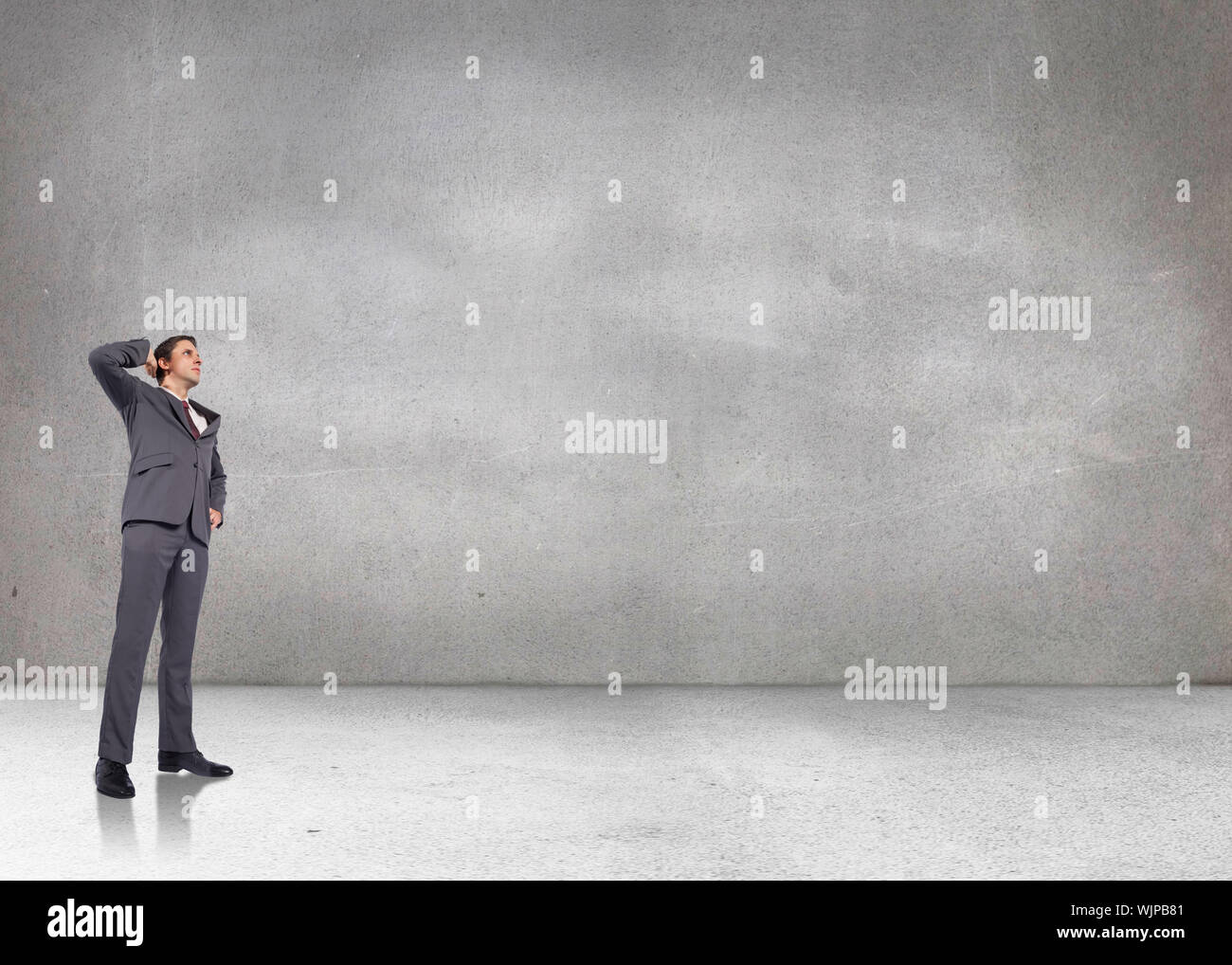 Thinking businessman scratching head against red arrow pointing up ...