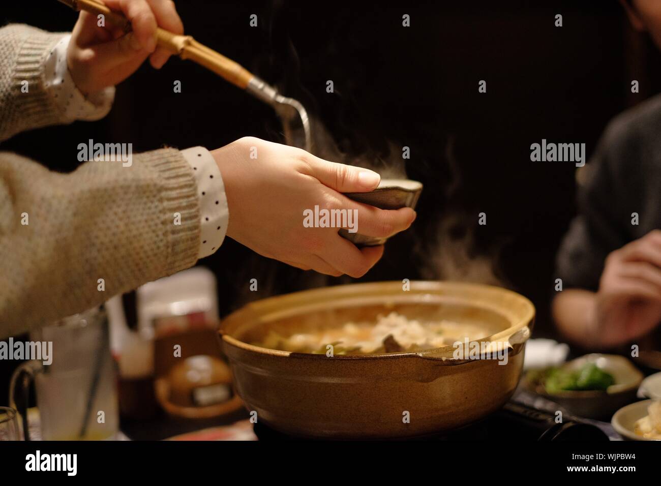 Woman pouring soup hi-res stock photography and images - Alamy