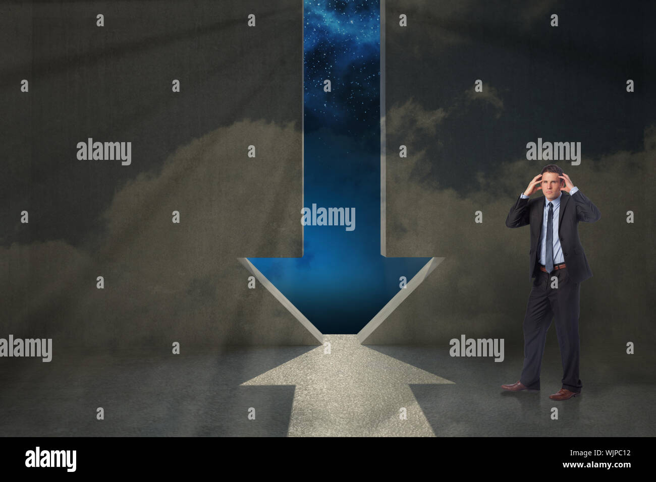 Stressed businessman with hands on head against arrow door in dark room ...