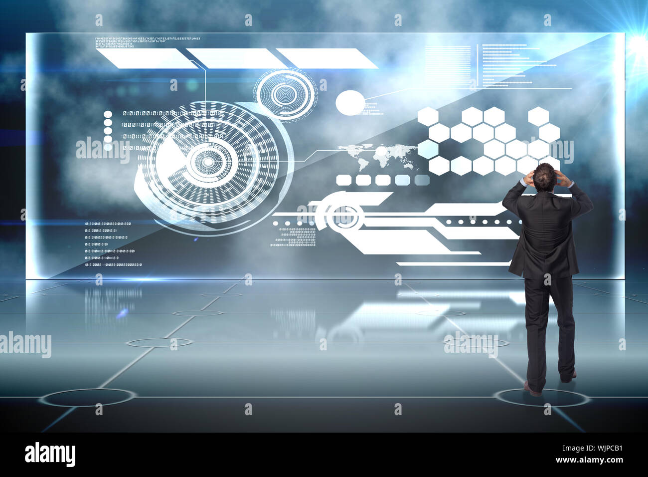 Stressed businessman with hands on head against futuristic technology ...