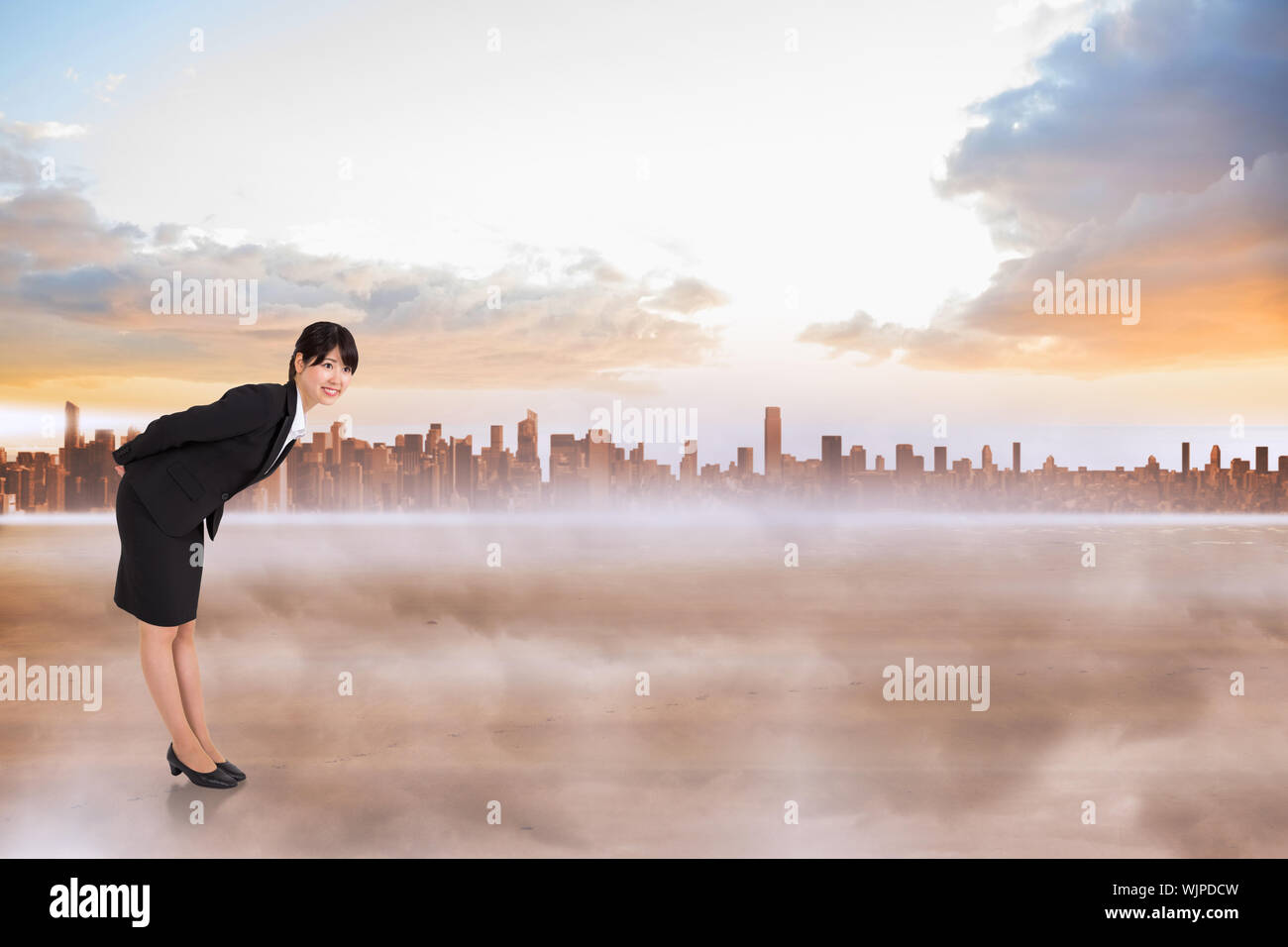 Smiling businesswoman bending Stock Photo - Alamy