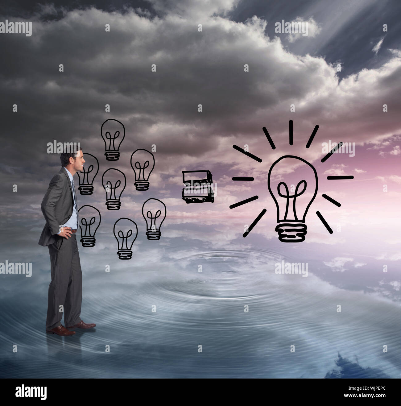 Smiling businessman with hands on hips against light bulbs graphic on ...
