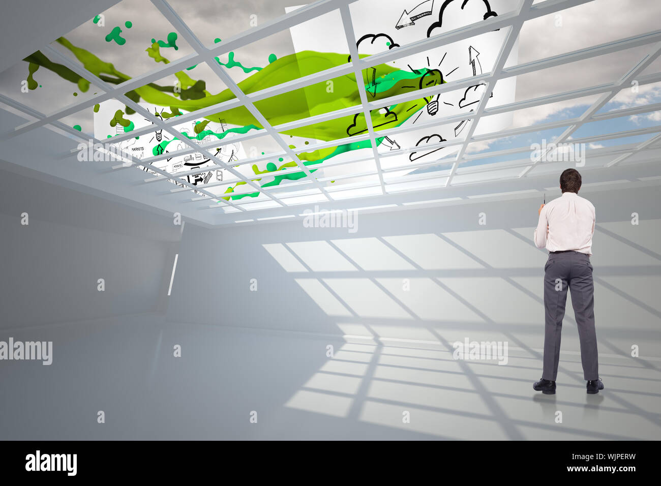 Thinking businessman against business papers flying past window Stock ...