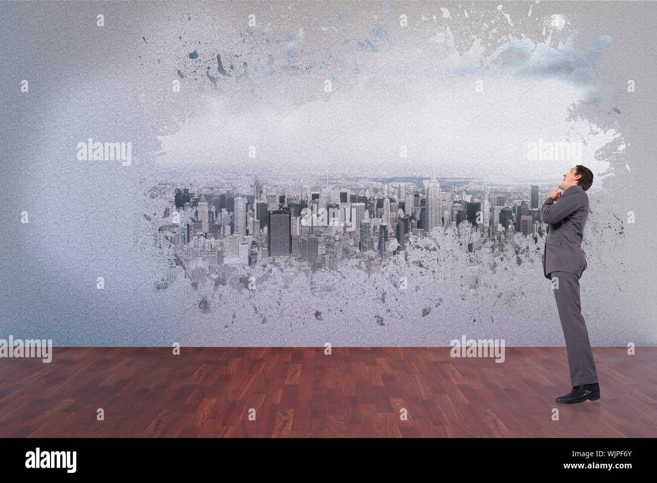 Splash on wall revealing cityscape Stock Photo - Alamy