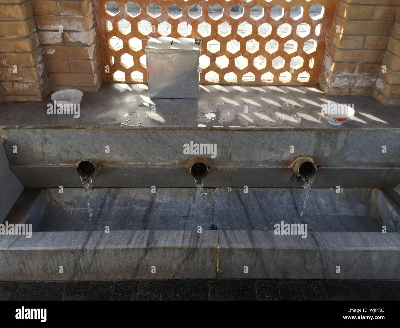 Water falling from pipe to trough day hi-res stock photography and ...