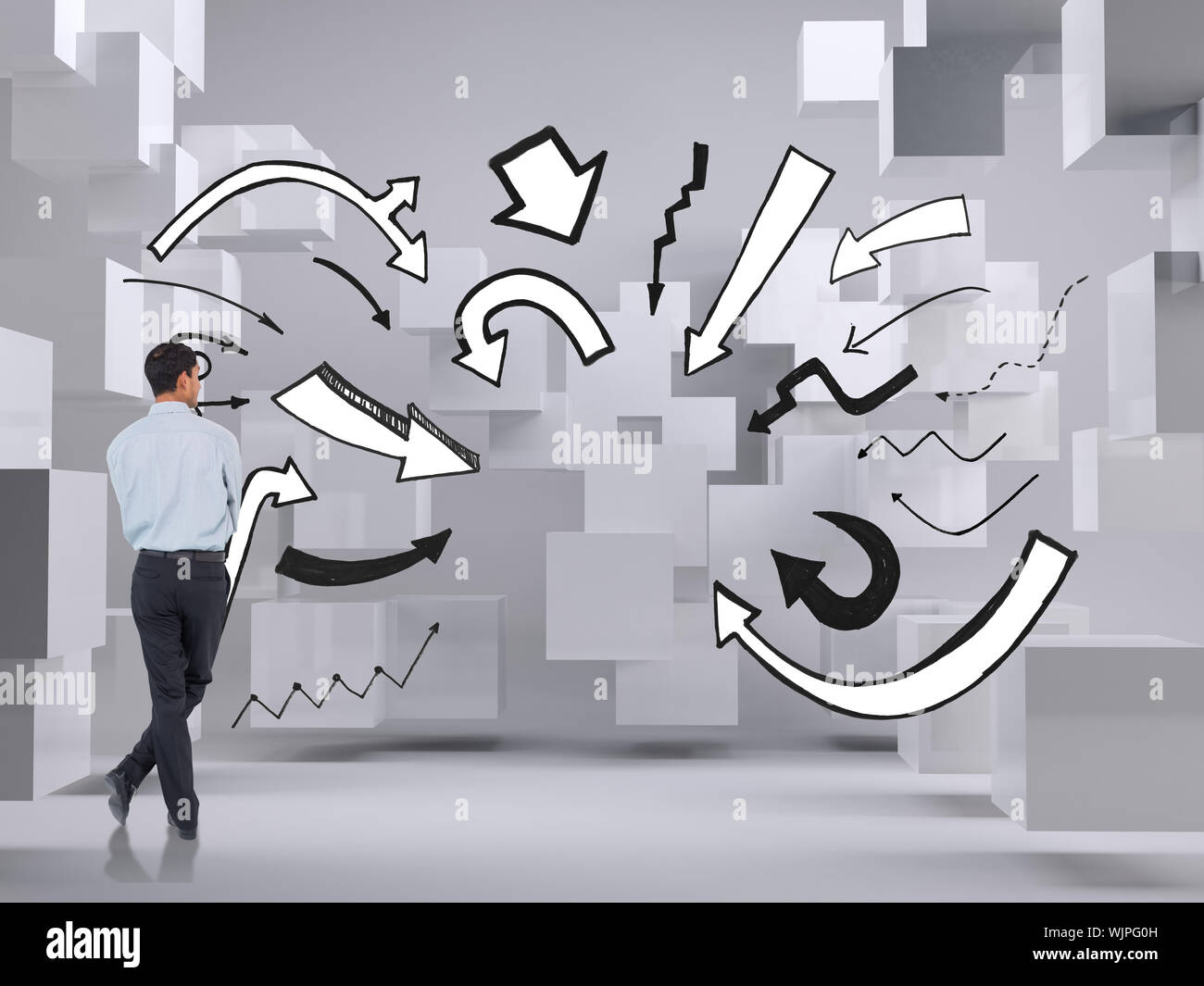 Smiling asian businessman against arrows on grey background with cubes Stock Photo - Alamy