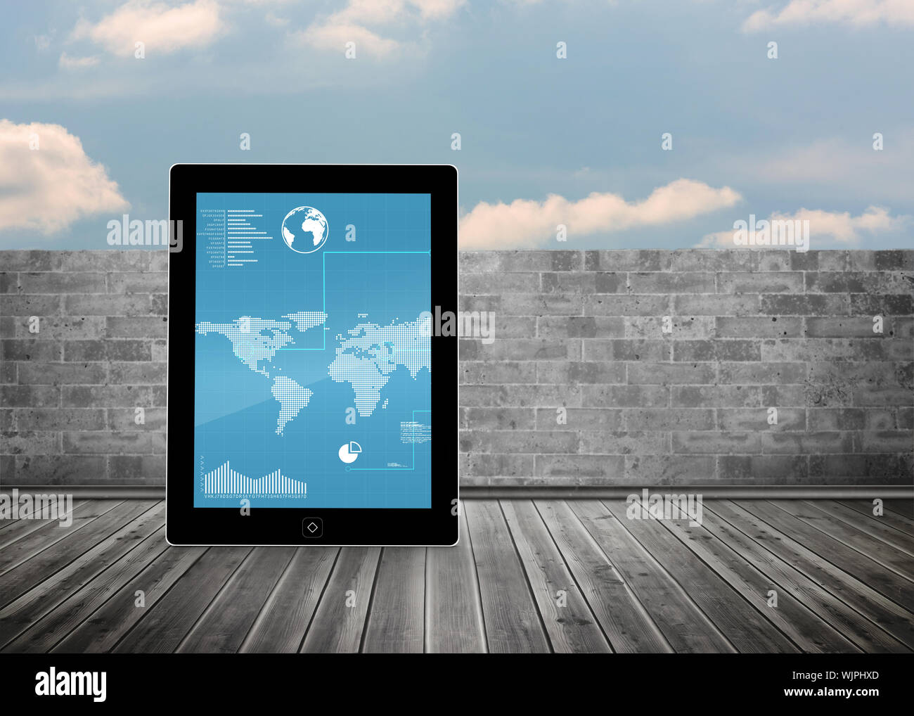 Map on tablet screen against brick lined wall covering half sky Stock ...