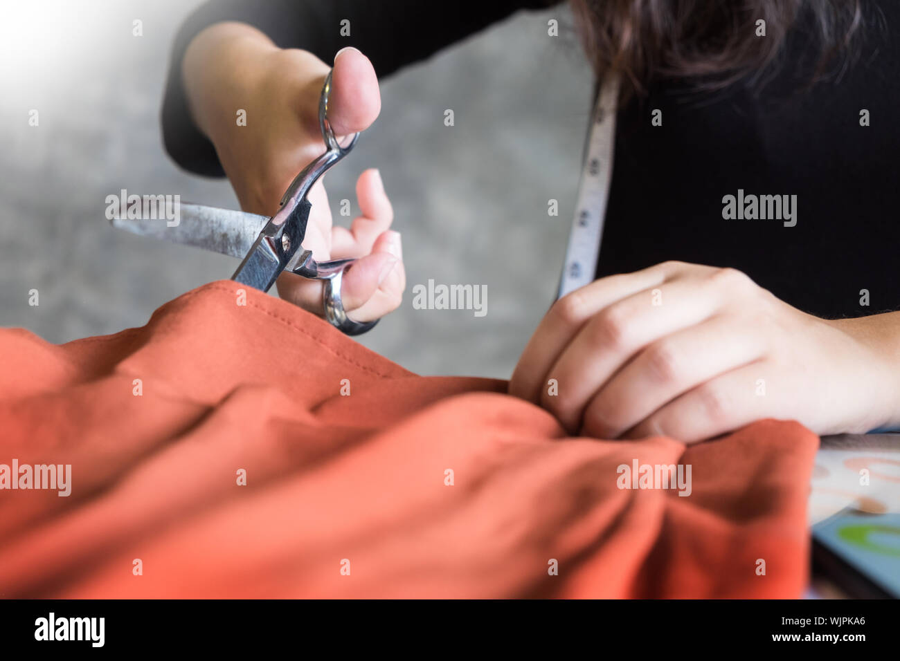 Tailor cutting cloth hi-res stock photography and images - Alamy