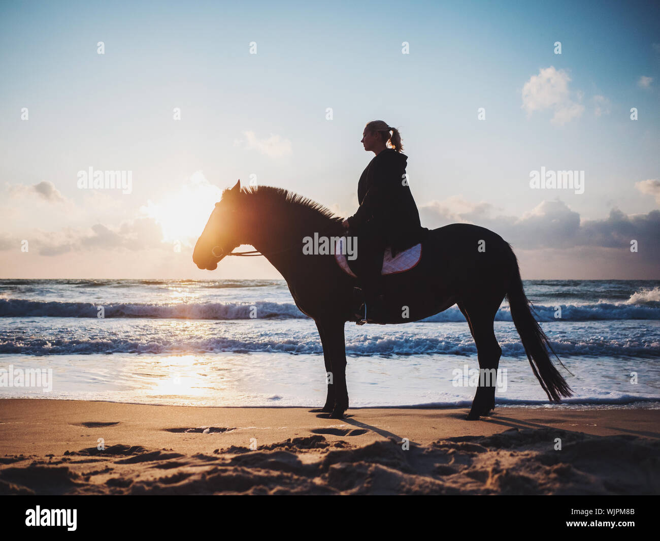 Woman sitting horse water hi-res stock photography and images - Alamy