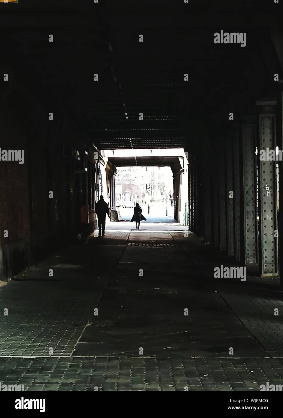 Silhouette man walking under bridge hi-res stock photography and images ...