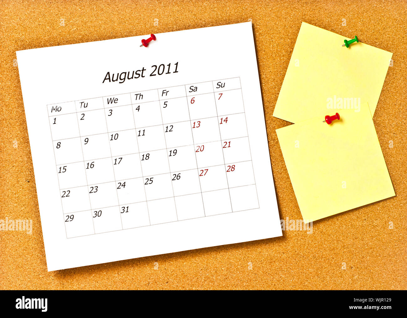 Cork bulletin board to pin a calendar page and yellow sticky paper ...