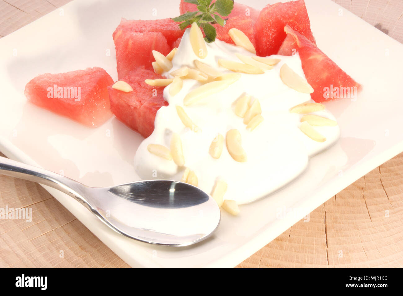 melon with cream fresh and almond slivers Stock Photo - Alamy