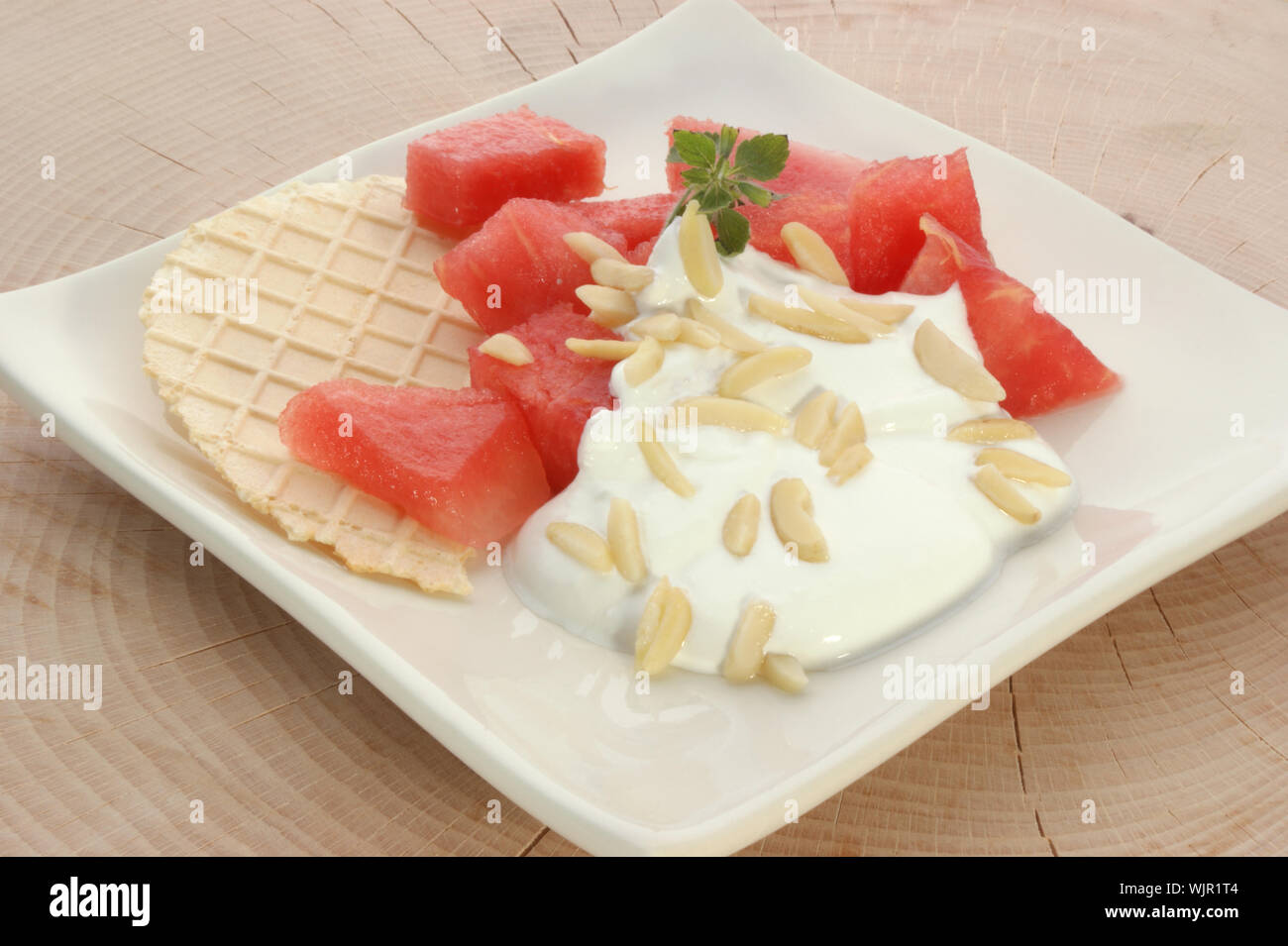 melon with cream fresh and almond slivers and wafer Stock Photo - Alamy