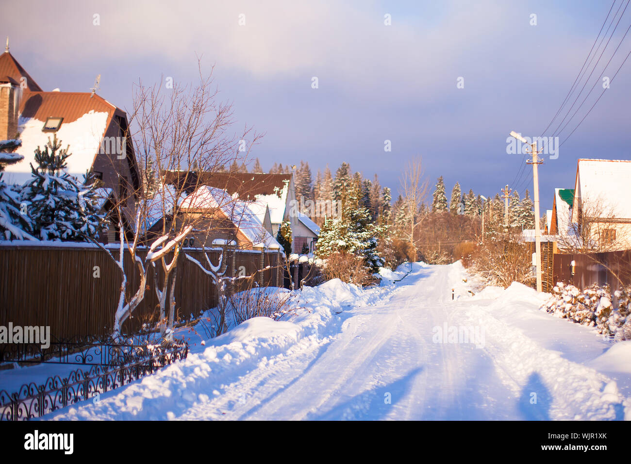 Winter snowy landscape with houses in a small village Stock Photo - Alamy