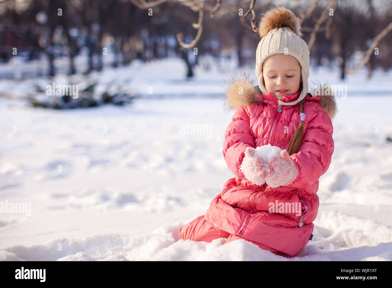 Adorable little girl outdoor in the park on cold winter day Stock Photo ...