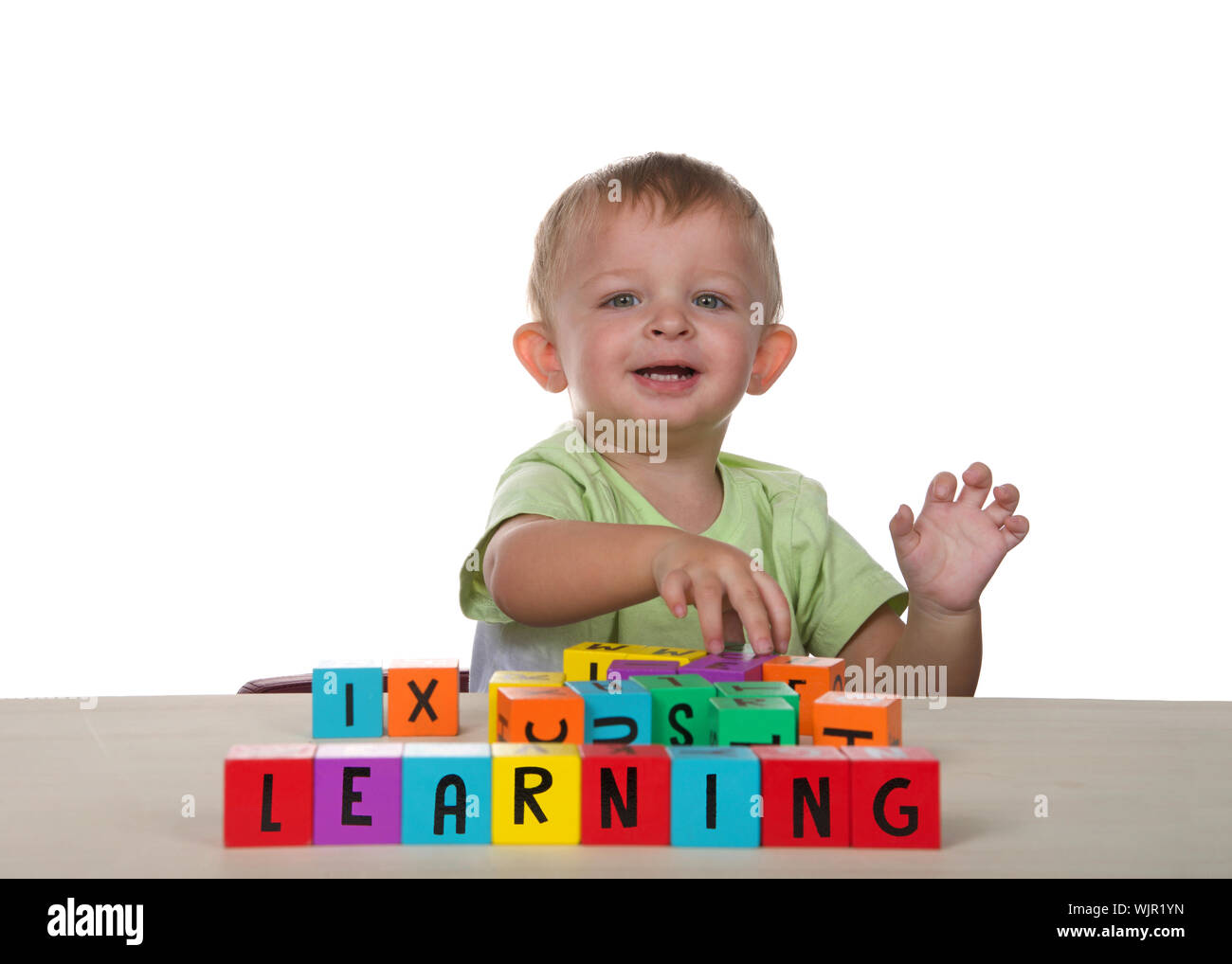 Caucasian toddler male child playing learning with colorful wooden ...