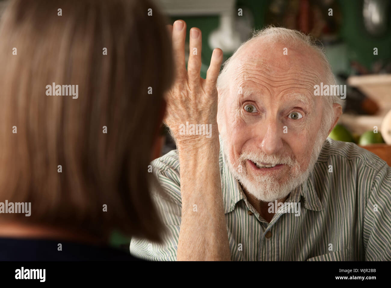 Senior couple at home in kitchen focusing on angry man Stock Photo - Alamy