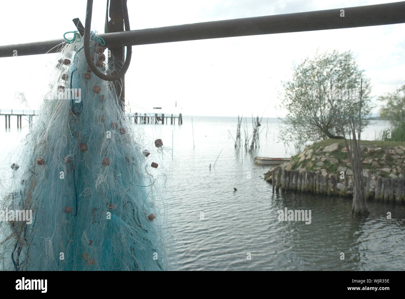 fishing-net with cork is hanging to dry Stock Photo - Alamy