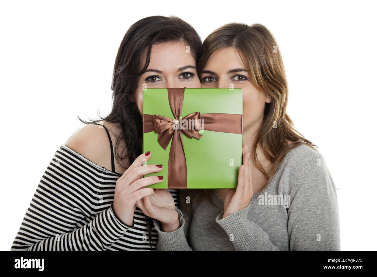 Two beautiful young womenÕs holding a present Stock Photo - Alamy