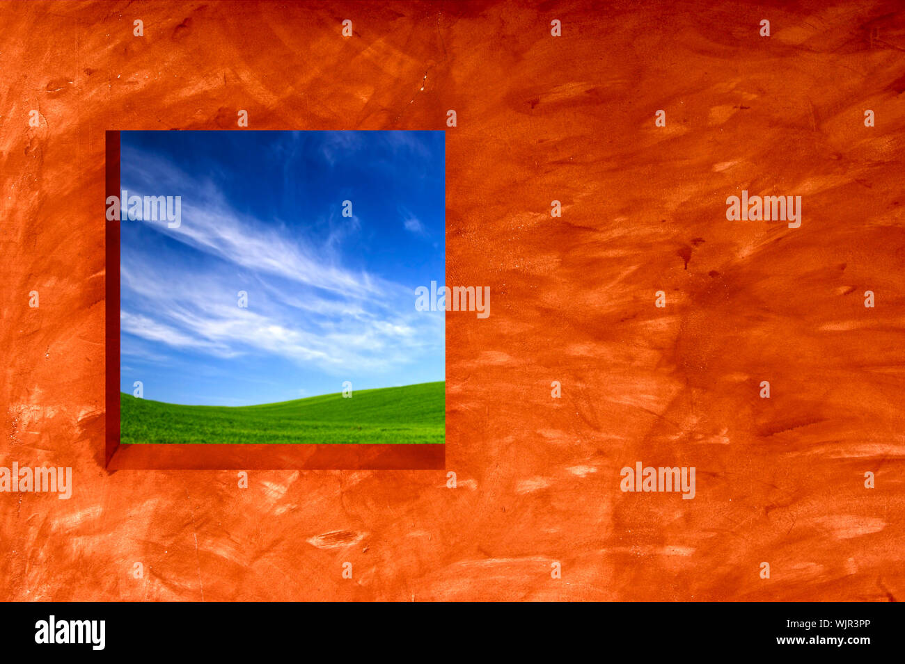 Orange wall with an open window for a beautiful green meadow Stock ...