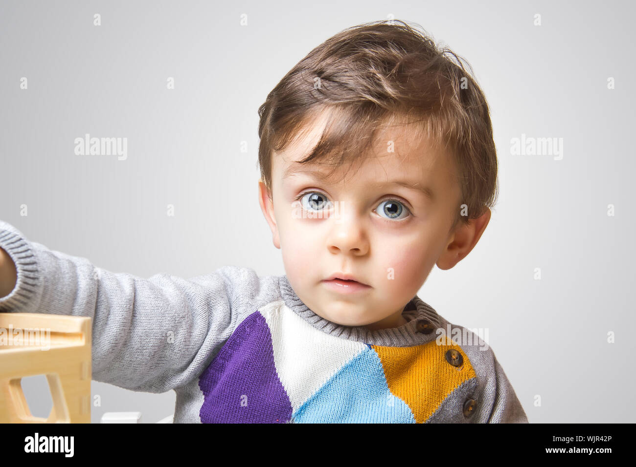 Child staring at the camera on white background Stock Photo - Alamy