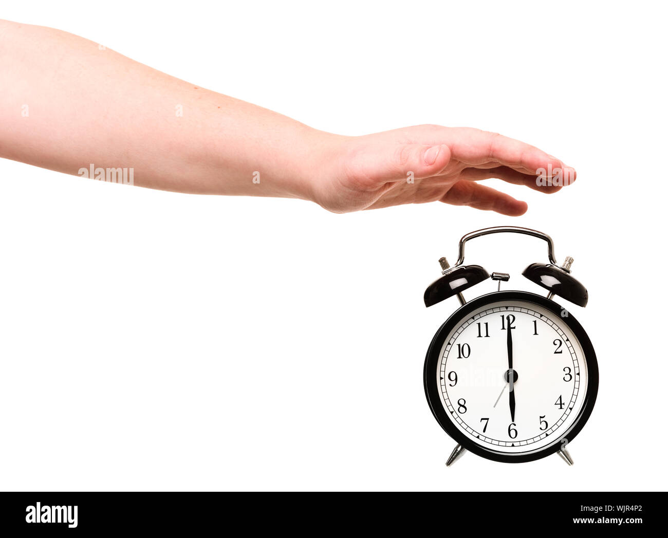 Hand turning of the alarm clock isolated on white background Stock ...