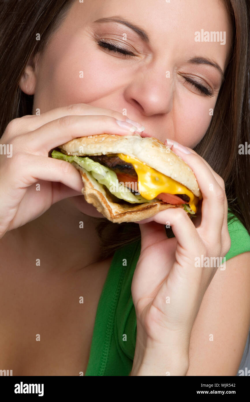 Beautiful woman eating hamburger food Stock Photo - Alamy